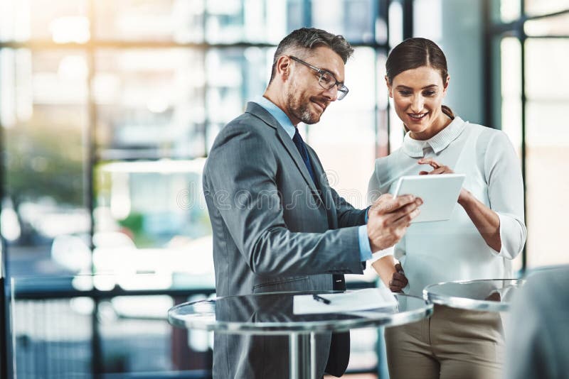 Getting Even More Done with Modern Tech. Two Colleagues Using a Digital ...