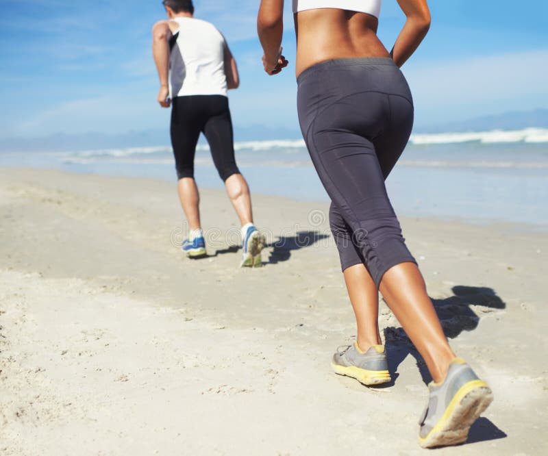 Getting Fit Together. Two People Running on the Beach. Stock Photo ...