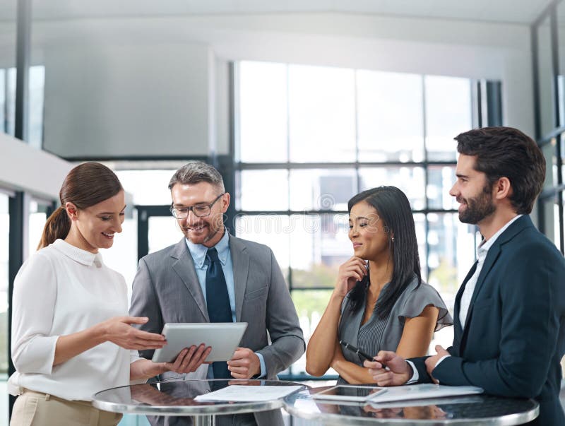 Getting the Groups Opinion. a Group of Businesspeople Looking Over a ...