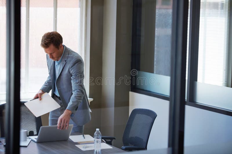 Getting His Documents in Order. a Businessman Looking at Paperwork in ...