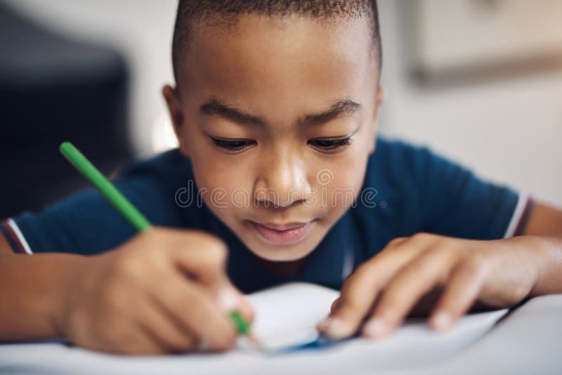 Getting His Homework Done before Playtime. a Young Boy Using Colouring ...