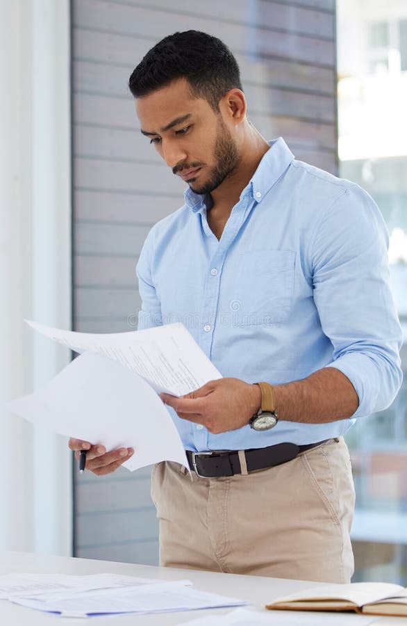 Getting His Paperwork in Order. Shot of a Young Businessman Going ...