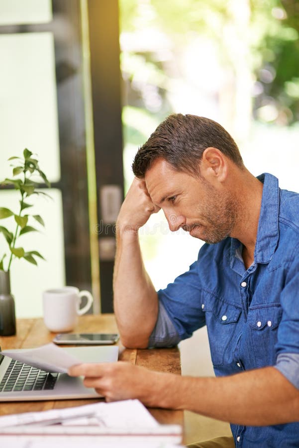 Getting His Work Done from Home Today. a Man Looking Over Some ...