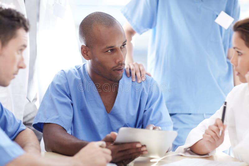 Getting Input from the Team. a Doctor and His Colleagues Have a ...