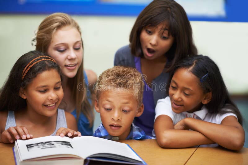 Getting Our Learn on. a Group of Students Looking through a Textbook ...