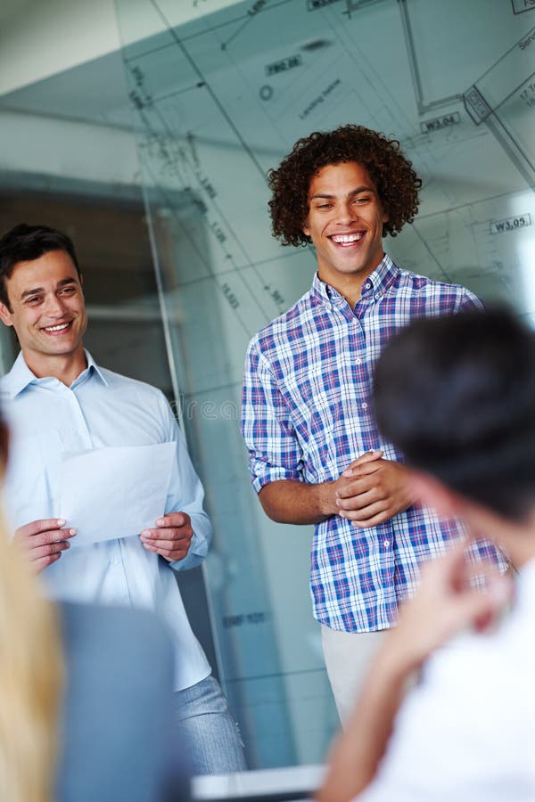 Getting Positive Feedback. Two Attractive Casual Businessmen Giving a ...