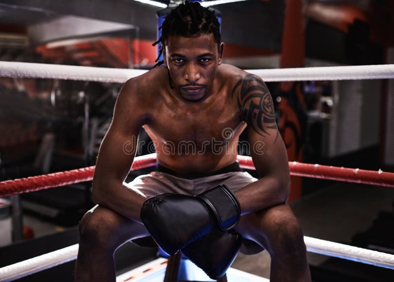 Getting Psyched for the Fight. a Muscular Ethnic Boxer Sitting in the ...