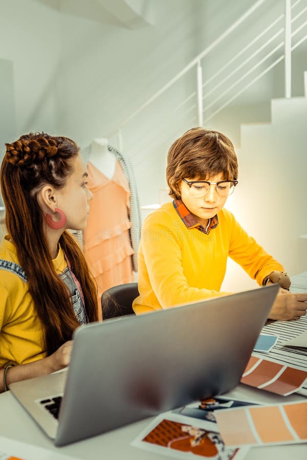 Brother and Sister Sitting in Front of Laptop Getting Ready for ...