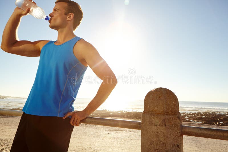 Getting Ready for the Rest of His Workout. a Man Drinking a Bottle of ...