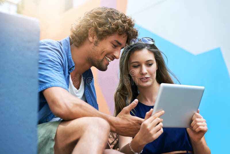 Getting Ready for Their Big Test Tomorrow. Two Students Using a Tablet ...