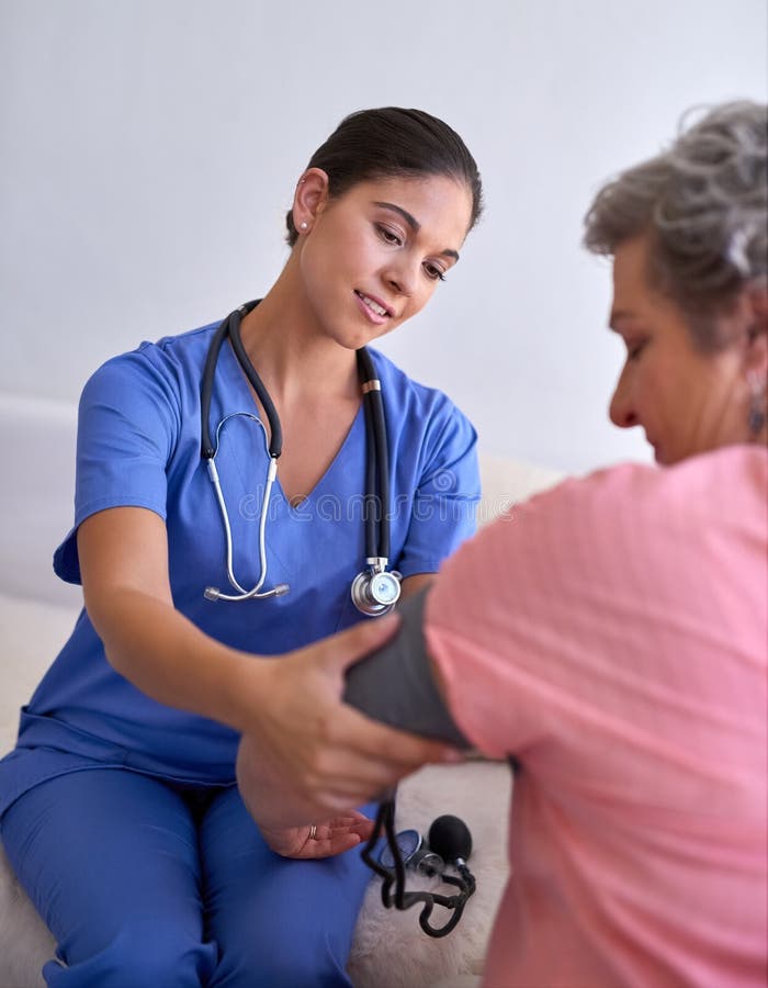 Getting a Routine Checkup. a Nurse Checking a Senior Patients Blood ... Getting a Routine Checkup. a Nurse Checking a Senior Patients Blood ...