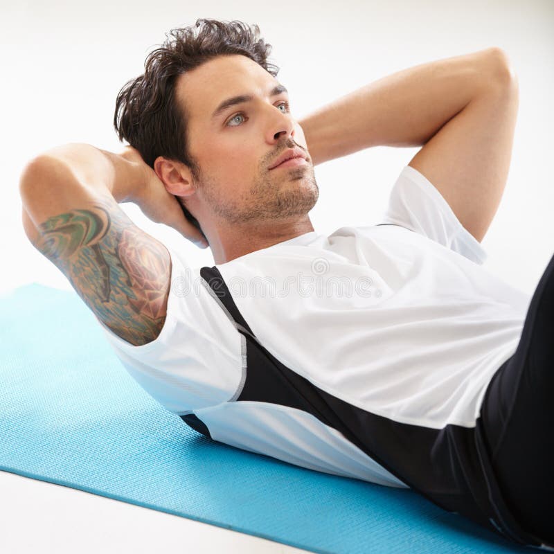 Getting a Six Pack Starts Here. a Handsome Young Man Doing Sit-ups ...