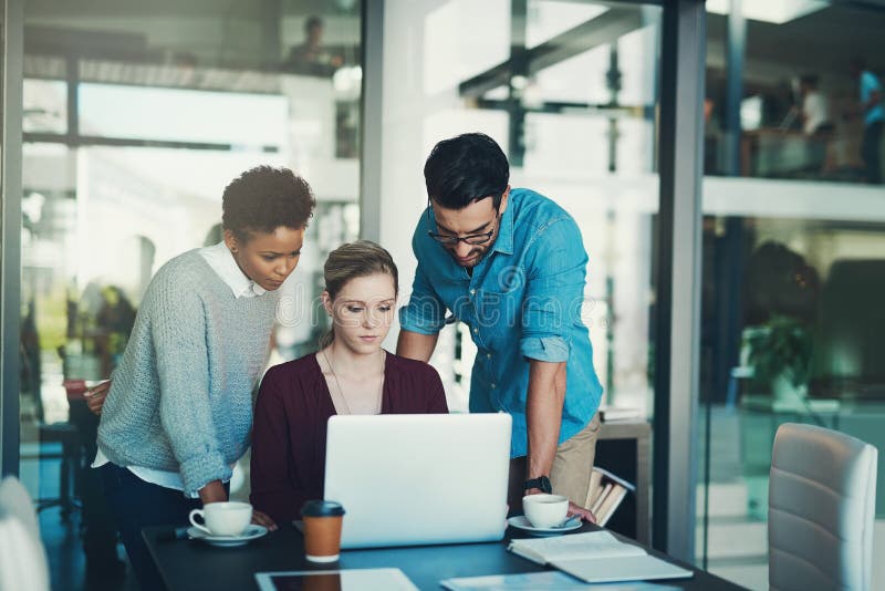 Getting Some Valuable Input. Three Businesspeople Gathered Around a ...