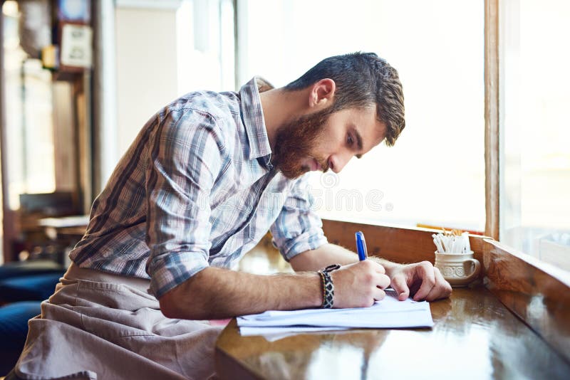 Getting Some Work Done. a Shop Owner Doing Some Paperwork. Stock Image ...