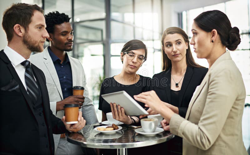 Getting Their Feedback. a Group of Businesspeople Looking at a Tablet ...