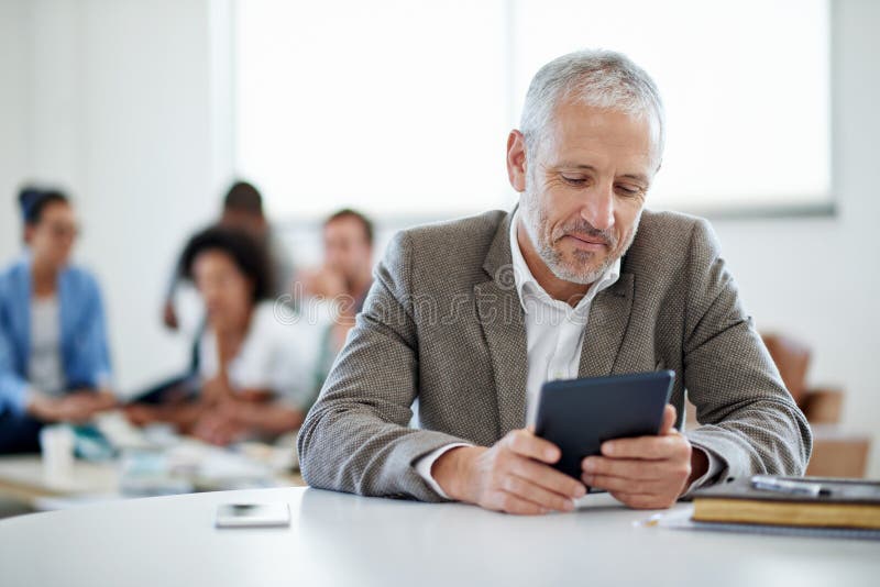 Getting To Grips with His New Work Tool. a Mature Businessman Using a ...
