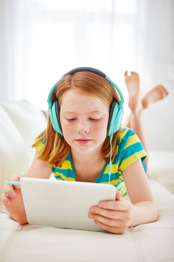 Getting To Know Technology. a Little Girl Using a Digital Tablet with ... Getting To Know Technology. a Little Girl Using a Digital Tablet with ...