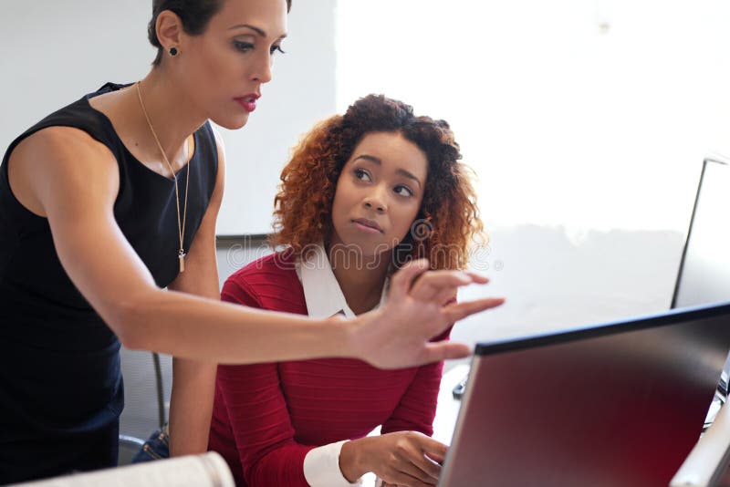 Getting Valuable Input from a Colleague. Two Businesswoman Working ...