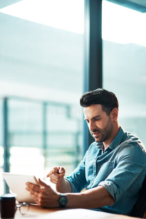 Getting Work Done in Digital Format. a Young Businessman Using a ...