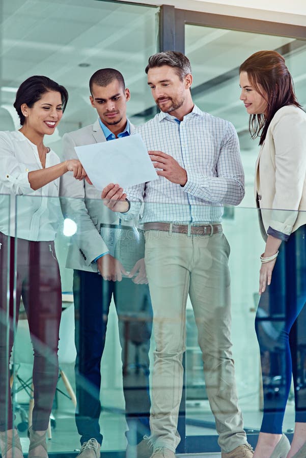 Getting Work Done, Together. a Group of Coworkers Talking Over Some ...