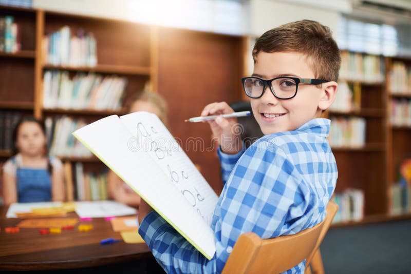 Getting into the Work. Portrait of a Cheerful Young Boy Doing School ...