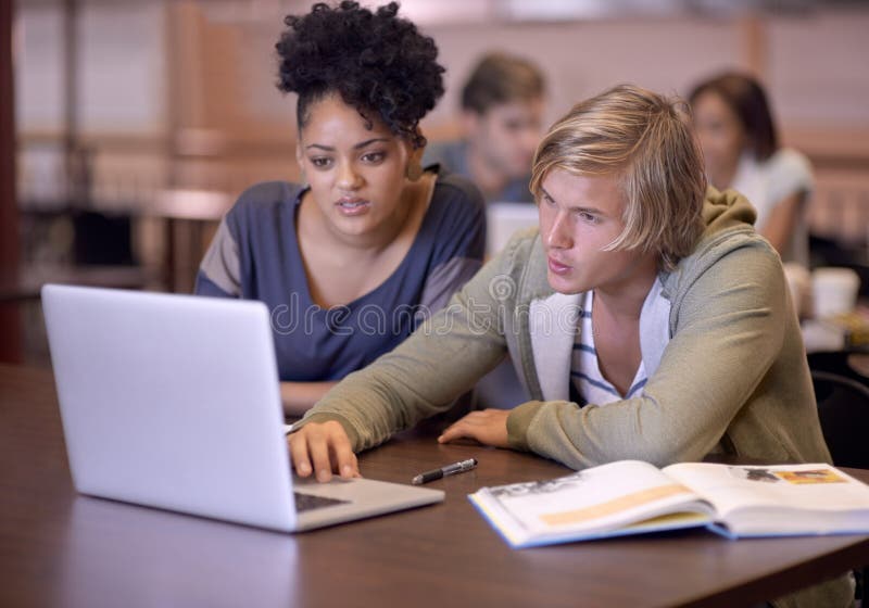 Getting through the Work Together. Two Students Researching Their ...