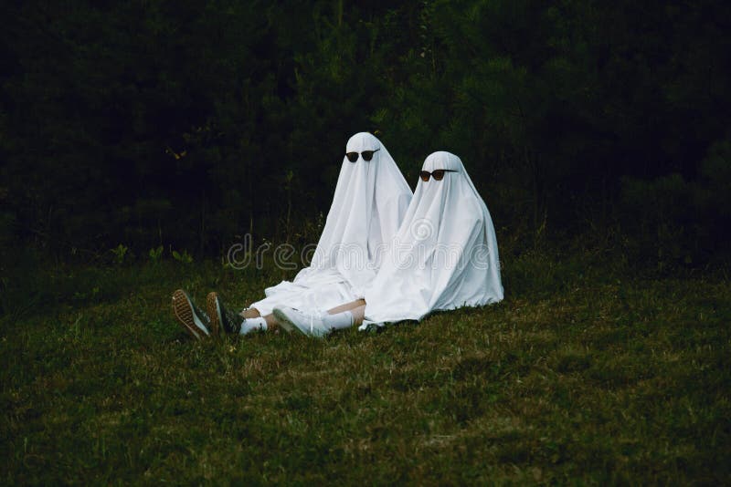 Ghost Couple Sitting in Grass Stock Photo - Image of sitting, fall ...
