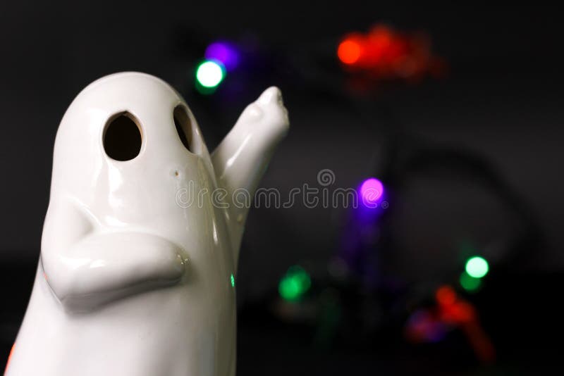 Ghost Figurine with Halloween Lights in the Back Stock Photo - Image of ...