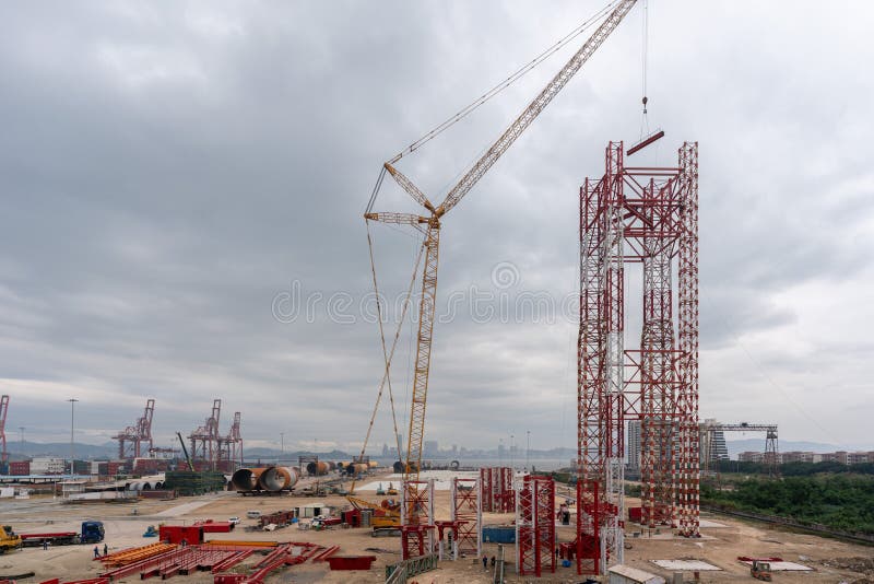 Giant Cranes and Elevated Structures on a Construction Site by the Sea ...
