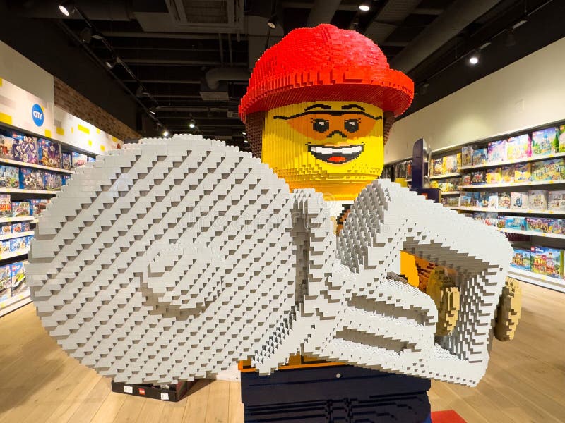 Giant Lego Figure with Red Hat Holding Construction Disc in Toy Store ...