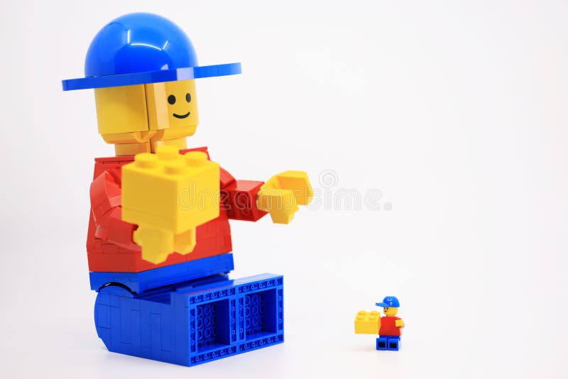 Giant Man Pick Up the Brick and Compare with the Mini One Editorial ...