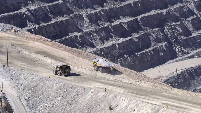 Giant Mining Trucks Transporting Minerals in an Open Pit Mine Stock ...
