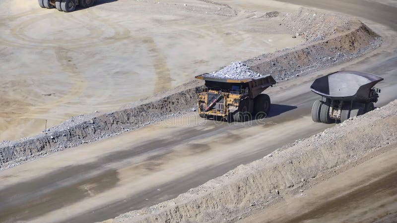 Giant Mining Trucks Transporting Minerals in an Open Pit Mine Stock Image - Image of cargo ...