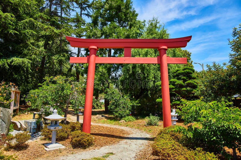 Giant Red Torii Gate in Japanese Garden with Stone Lanterns Lining Path ...