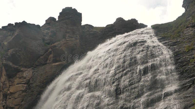 Giant Waterfall Flows Down from a High Mountain, Water Flows Over a ...