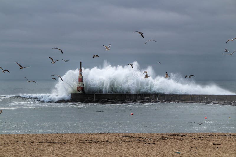Giant Waves Breaking on the Breakwater and the Lighthouse Stock Image ...