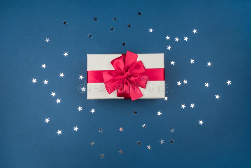 Gift Box with Big Red Bow on Blue Background with Silver Sequins Stock ...
