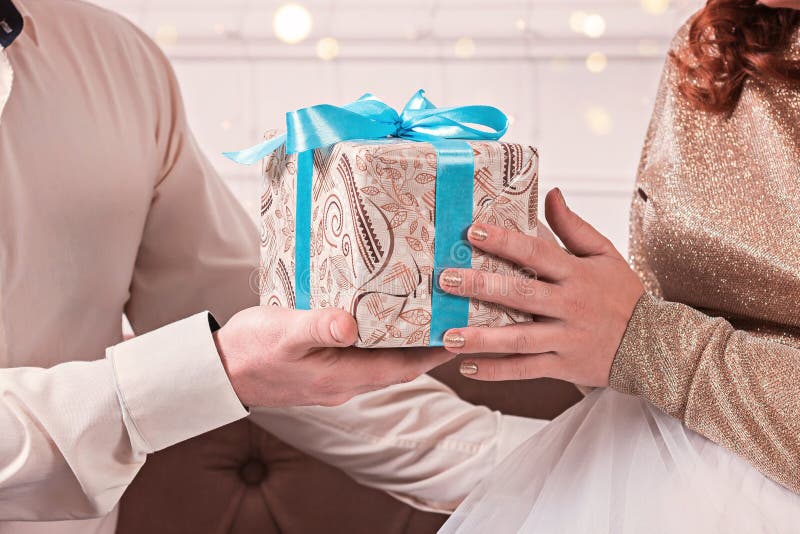 Gift Box with Blue Ribbon in Hands of Romantic Couple Stock Photo ...