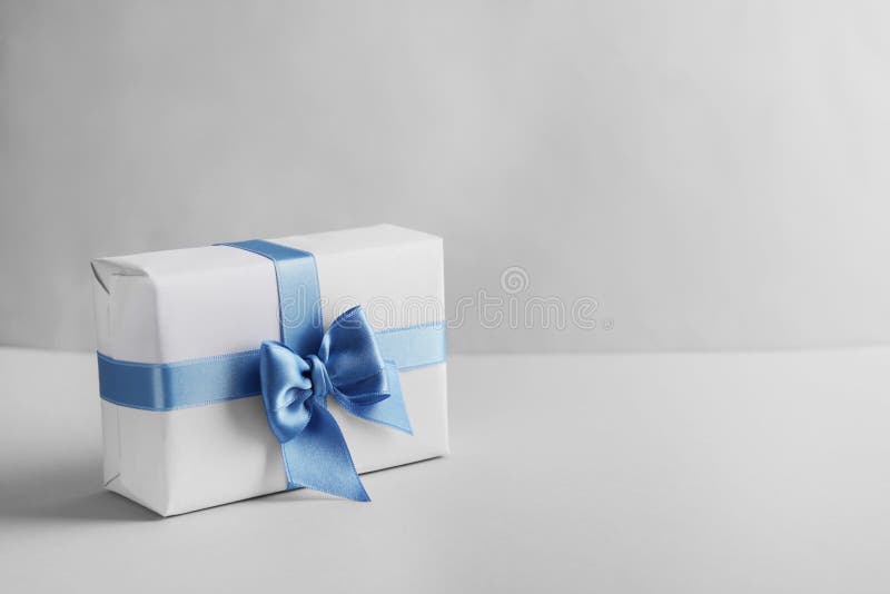Gift Box with Blue Ribbon on Light Background Stock Image - Image of ...