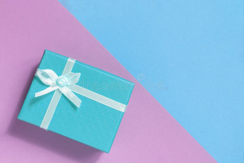 Gift Box with a Bow of Light Blue Color on a Pink and Blue Background ...