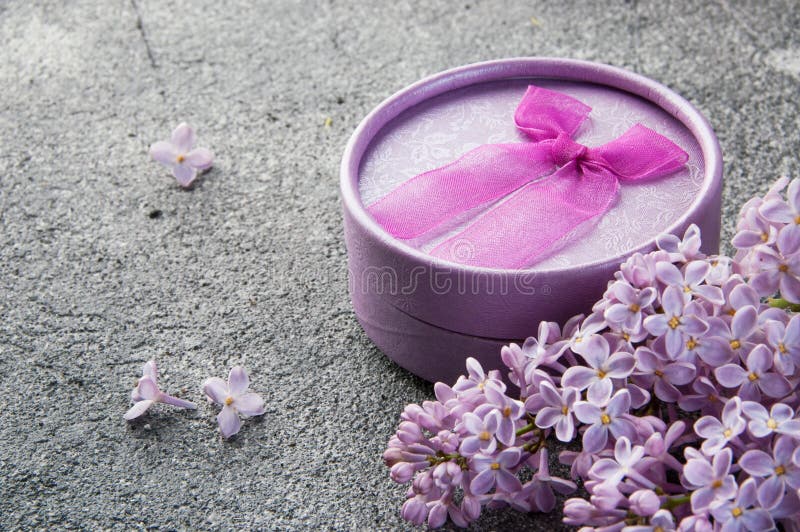 Gift Box and Bunch of Lilac on Gray Concrete Background Stock Photo ...