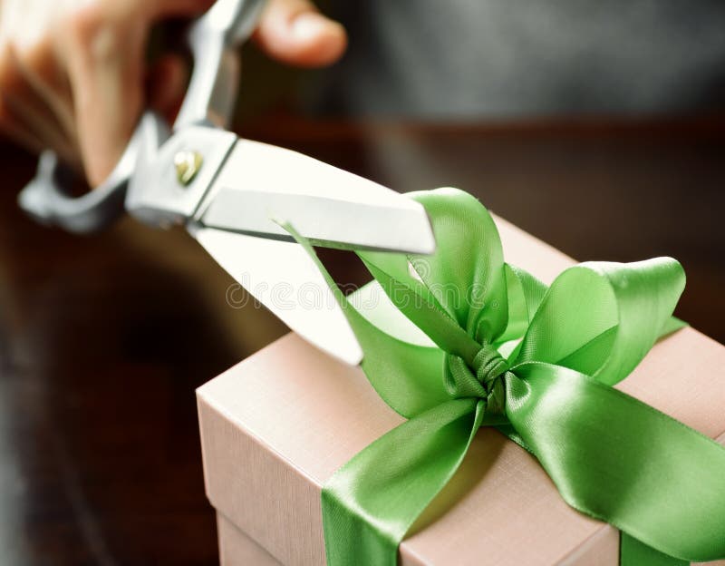 Decorating Gift Box with Green Ribbon Using Scissor Stock Photo - Image ...