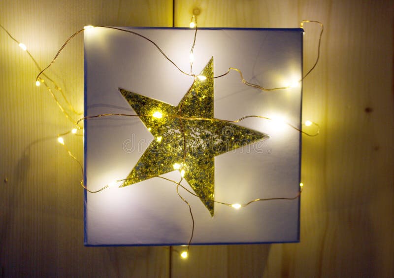 Christmas Gift - Gift Box with Golden Star and Light Chain Stock Photo ...