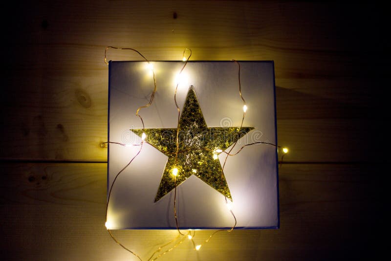 Christmas Gift - Gift Box with Golden Star and Light Chain Stock Image ...