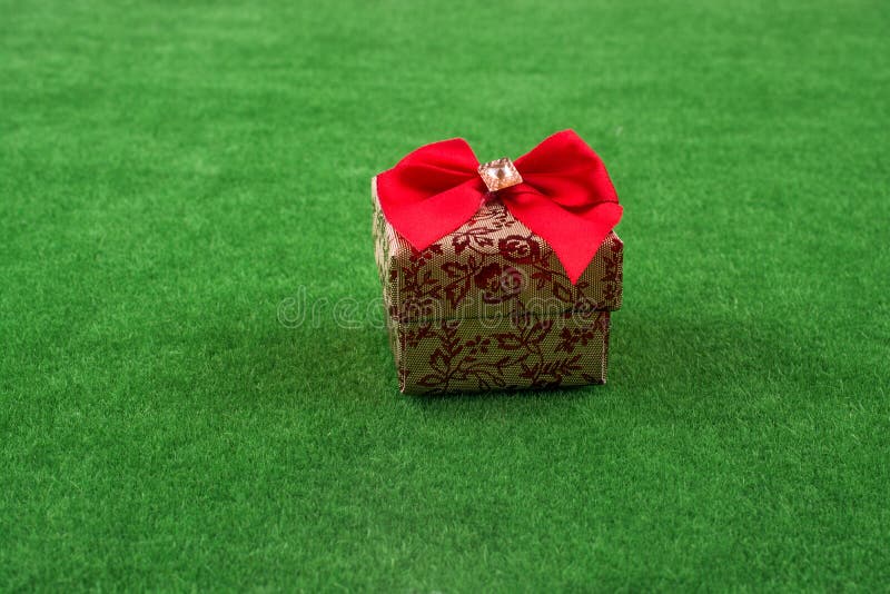 Gift box on green grass stock photo. Image of surprise - 80147762