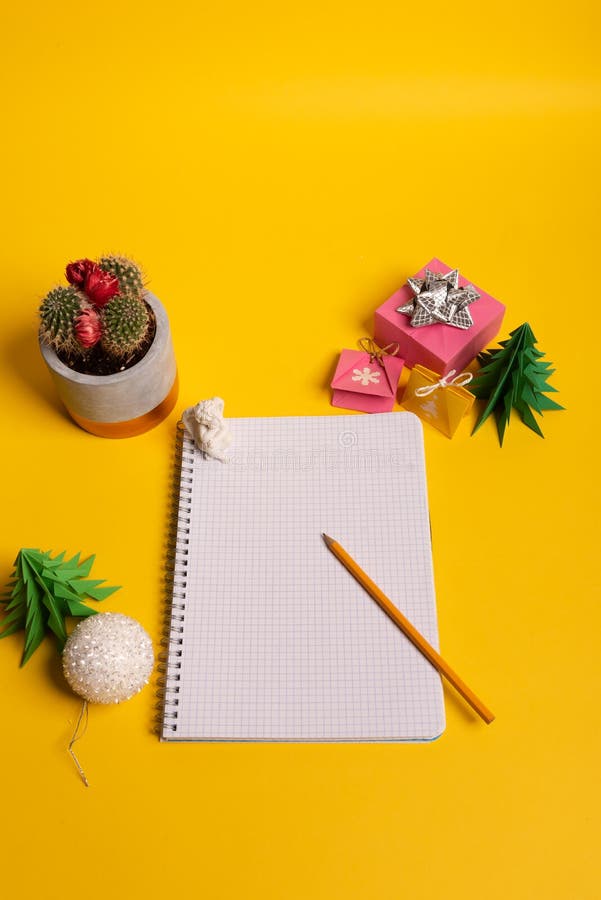 Gift Box and Green Origami Trees with Notepad on Yellow Desk, Table ...
