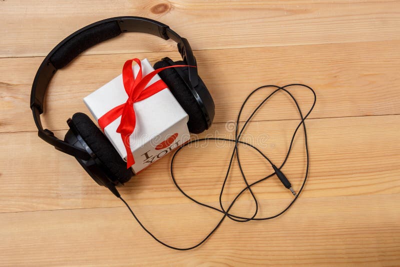 Gift Box with Headphones on Wooden Table Stock Image - Image of sound ...