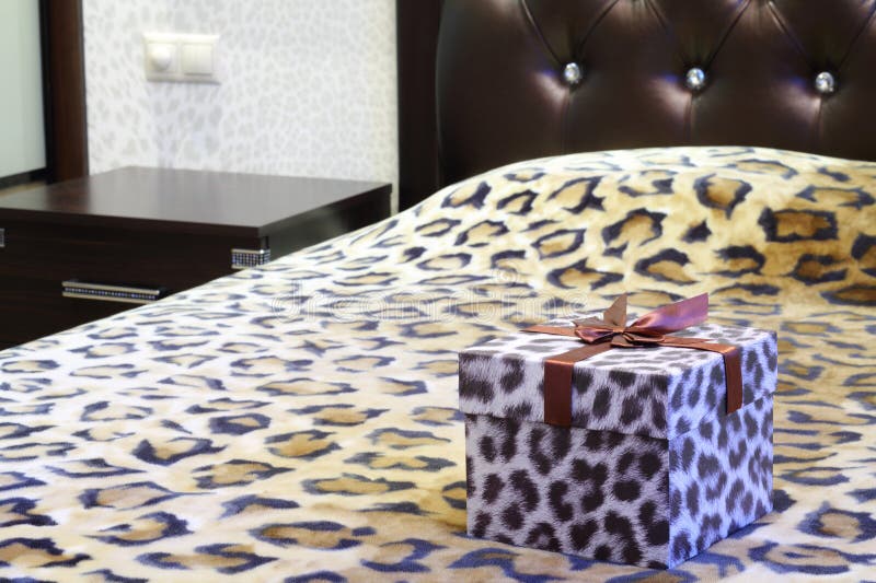 Gift Box with a Leopard Pattern on the Bed with Stock Photo - Image of ...
