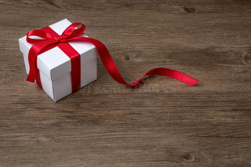 Gift Box with Red Bow on Rustic Table, Christmas or Another Celebration ...