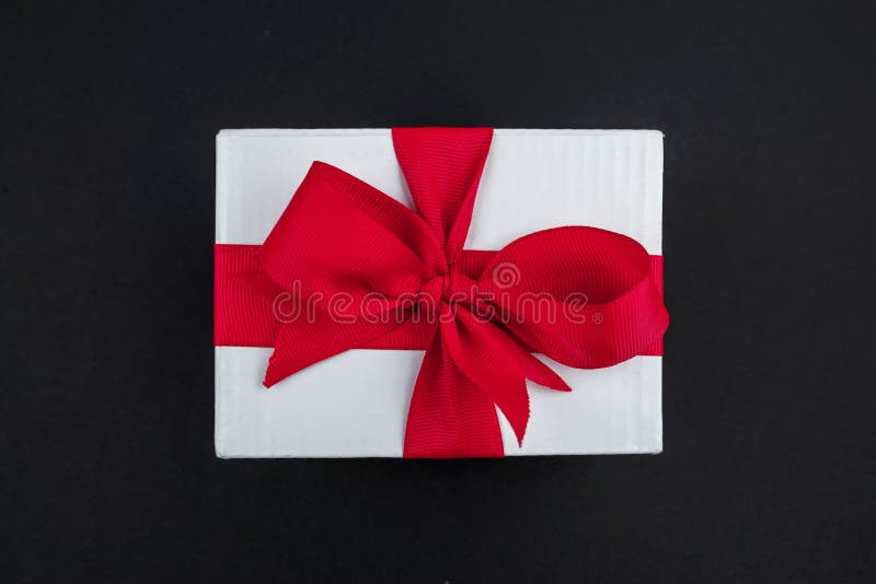 Gift Box with a Red Ribbon on a Black Surface Stock Photo - Image of ...